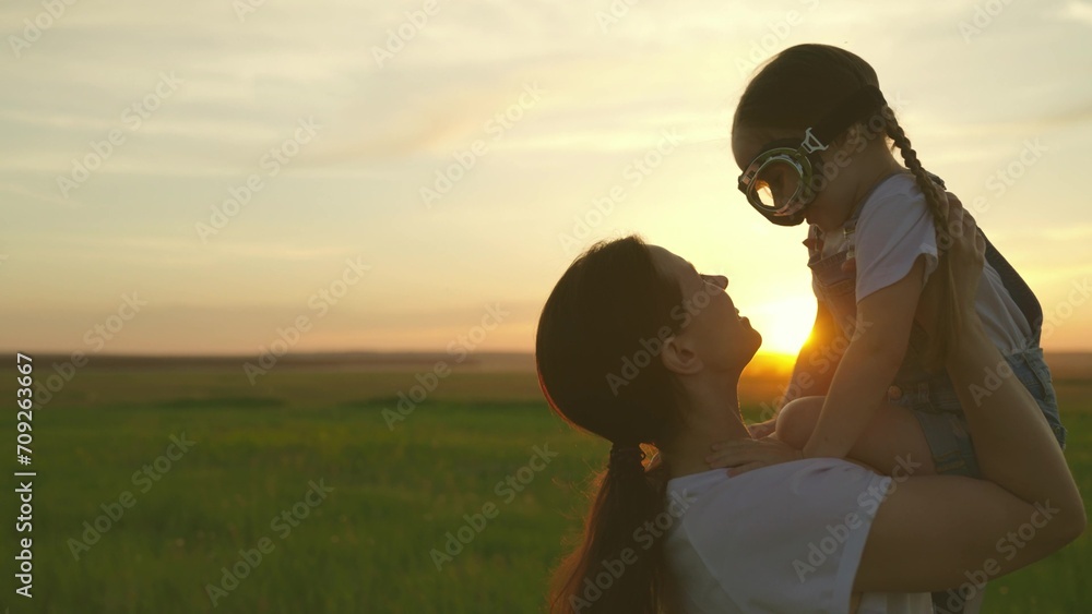 Little girl smiles, plays with his mother in outdoor. Happy family ...