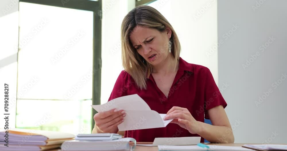 Blonde woman opens letter and becomes outraged by content Stock-Video ...