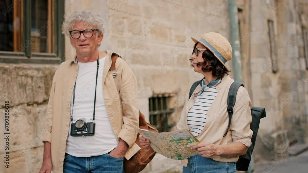 Camera view frontal view of older Caucasian couple trying to navigate ...