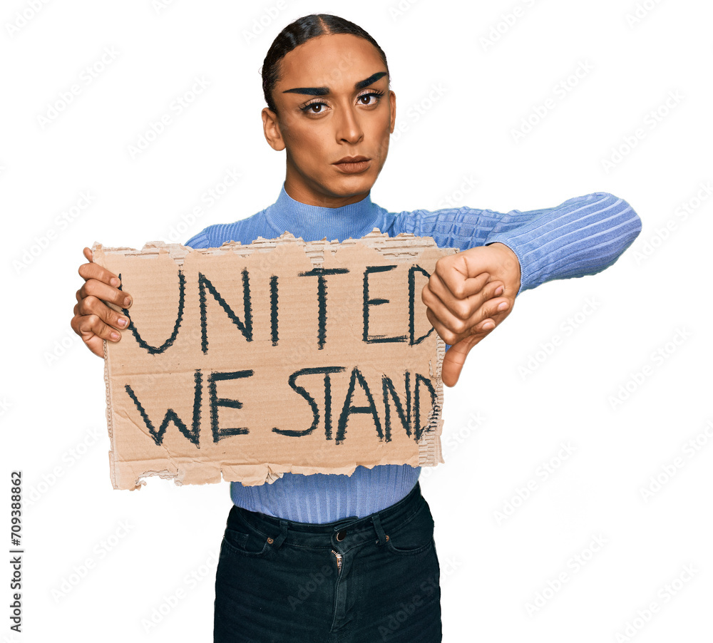 Hispanic transgender man wearing make up and long hair holding united ...