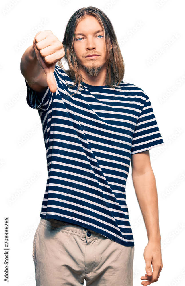 Handsome caucasian man with long hair wearing casual striped t-shirt ...