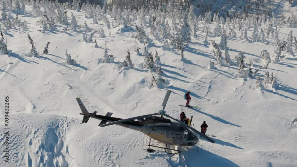 In snow helicopter aerial top view against forest mountains backdrop ...