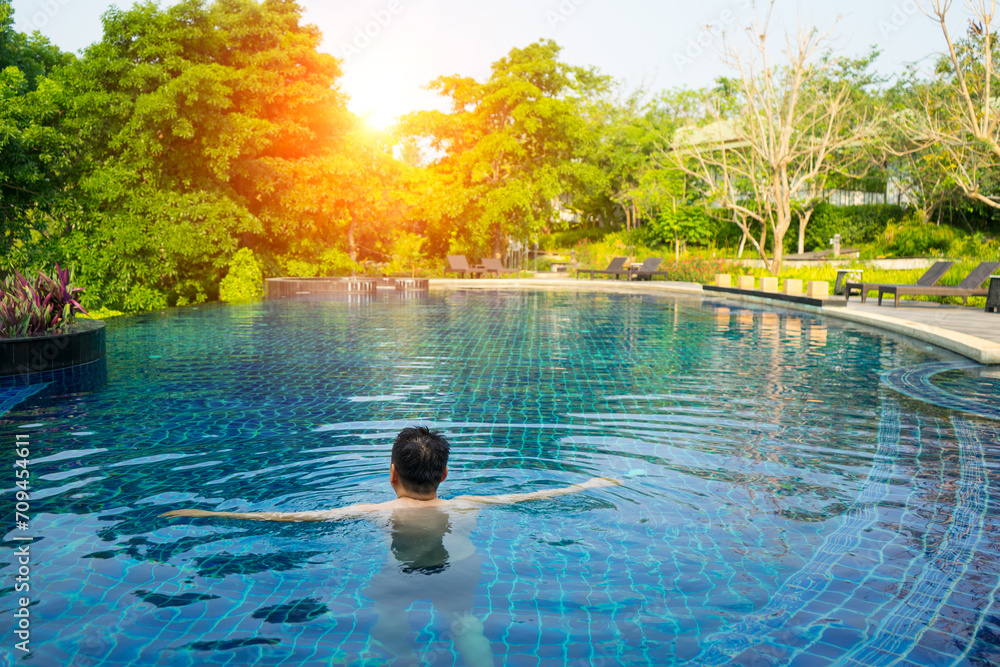 Man tourist to take a bath in the swimming pool near the forest park ...