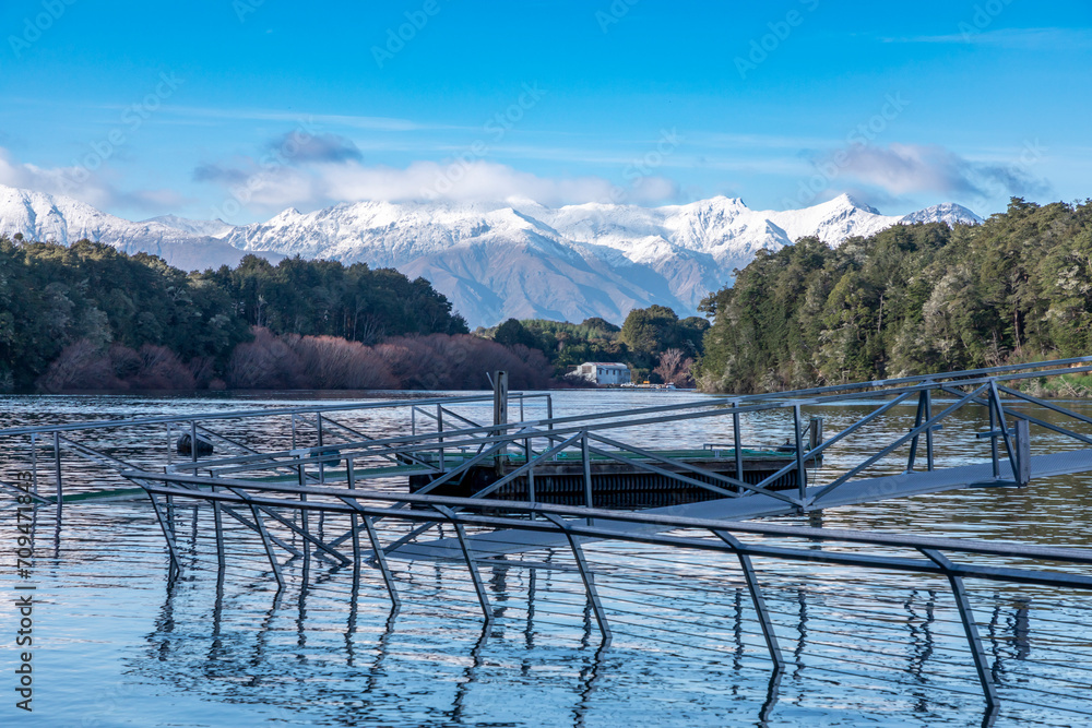 Photograph of snow-capped mountains and flood waters in the Waiau River ...