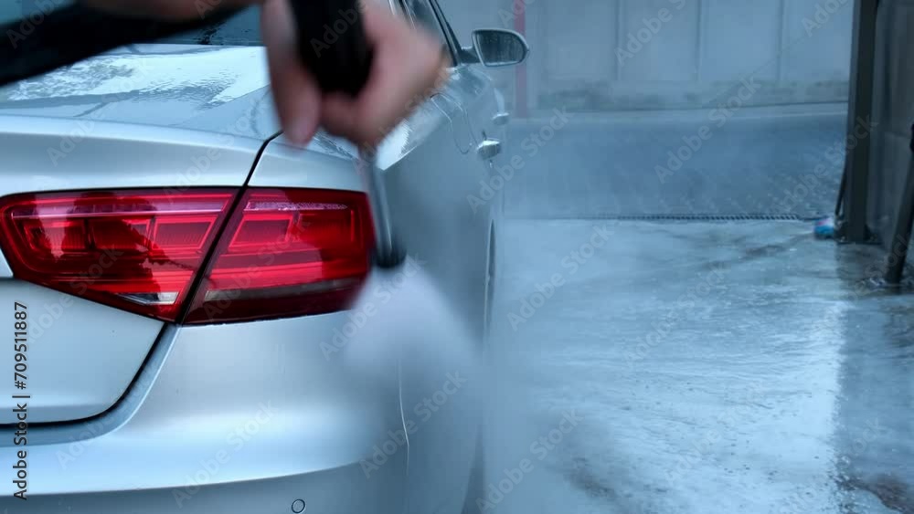 Washing luxury silver car on touchless car wash. Washing sedan car with ...