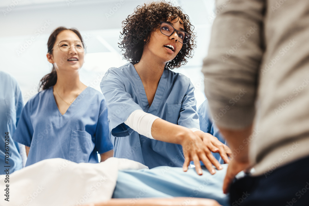 Diverse young women getting medical training in a hospital Stock Photo ...