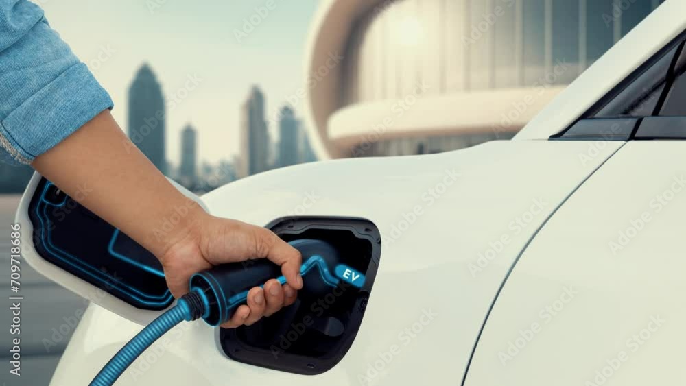 Man insert smart EV charger to electric car and recharging from EV ...