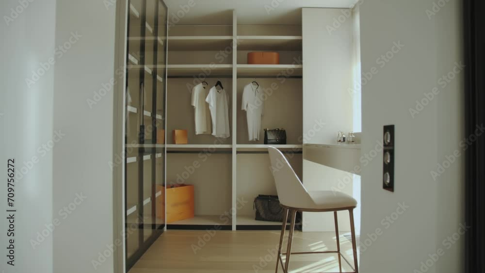 Camera move forward to dressing room with shelves. Modern wardrobe with ...