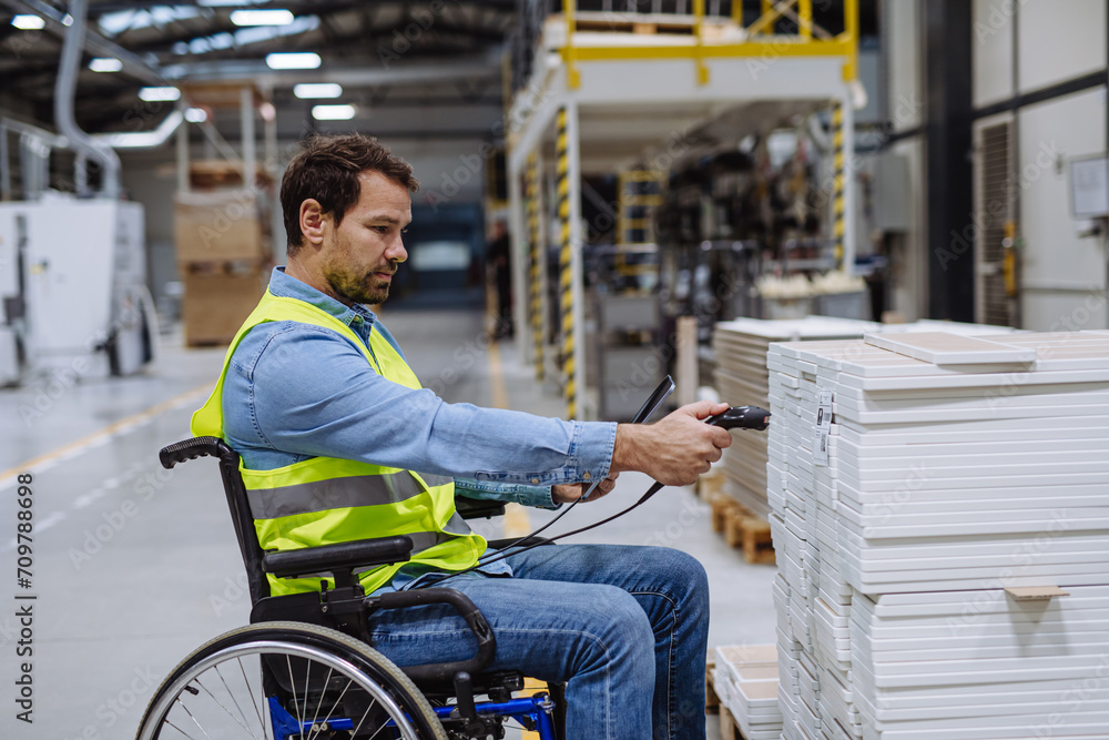 Portrait of man in wheelchair working in modern industrial factory ...