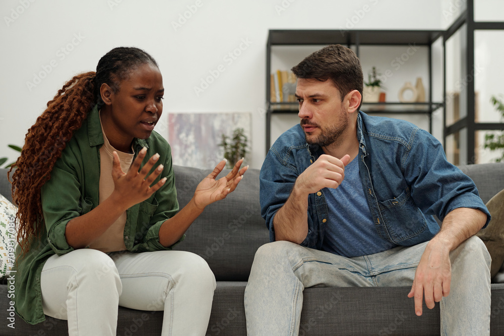 Young African American woman trying to explain something to her husband ...