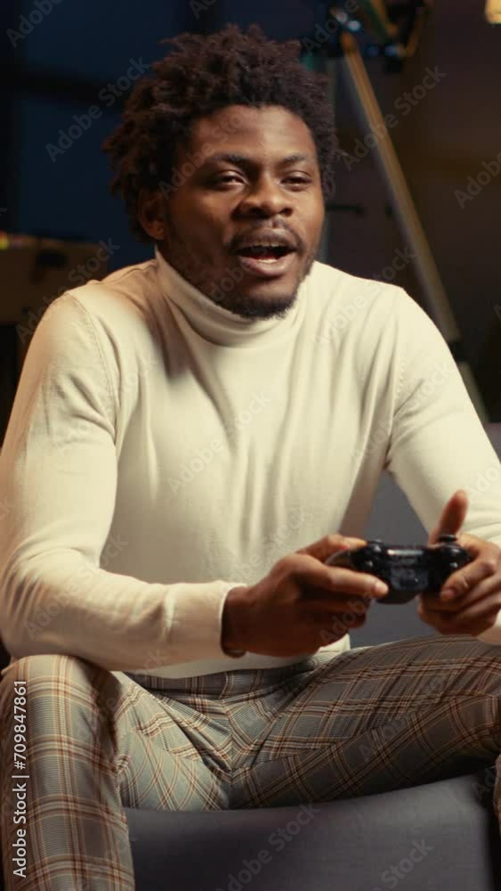 Vertical video Man arriving in gaming room, ready to play videogame on ...