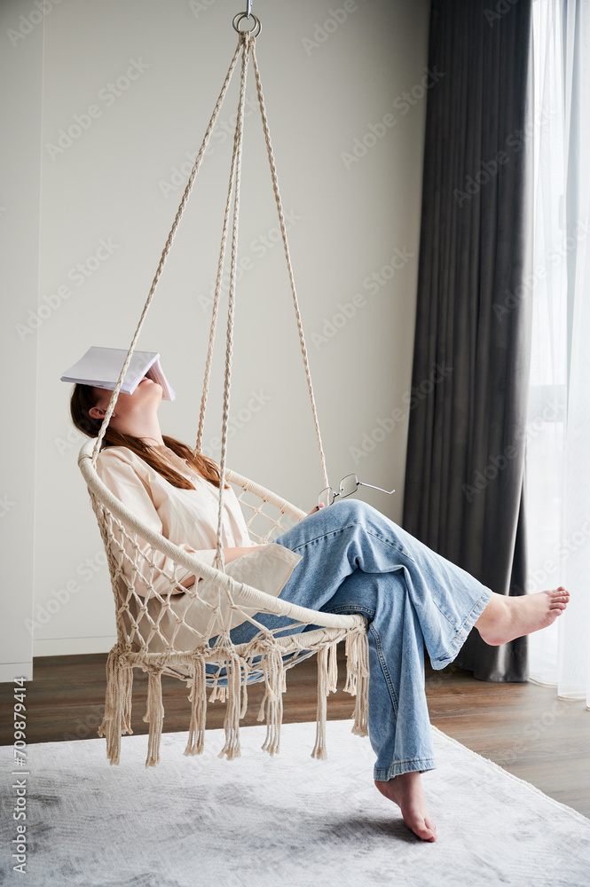 Tired girl fall asleep after reading a book. Young female relaxing in ...