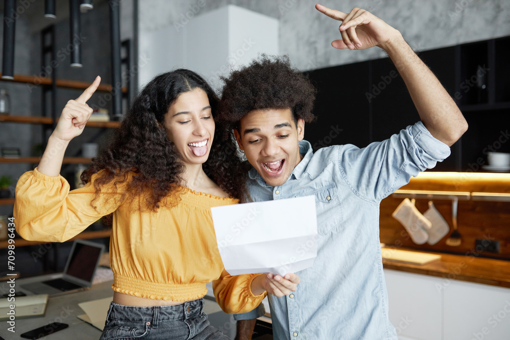 Happy excited african american young couple feeling euphoric while ...