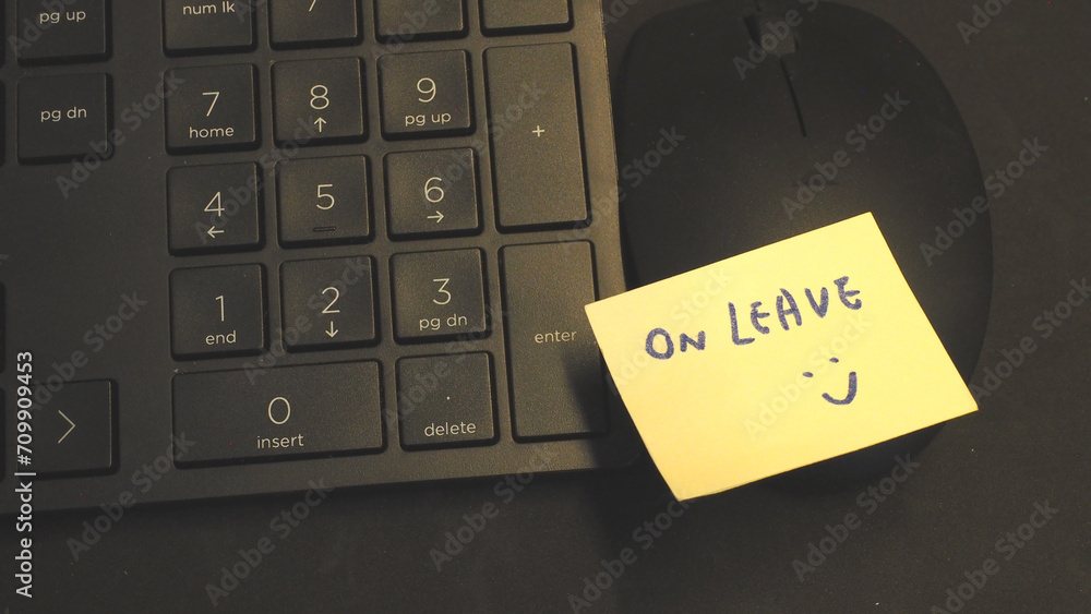 yellow sticky note with handwritten words "On Leave" and a smiley ...