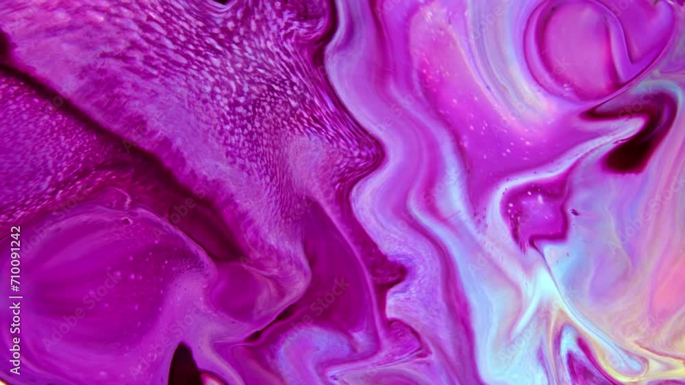 Close-up shot of multi-colored paint mixture boiling in a mixer. They ...