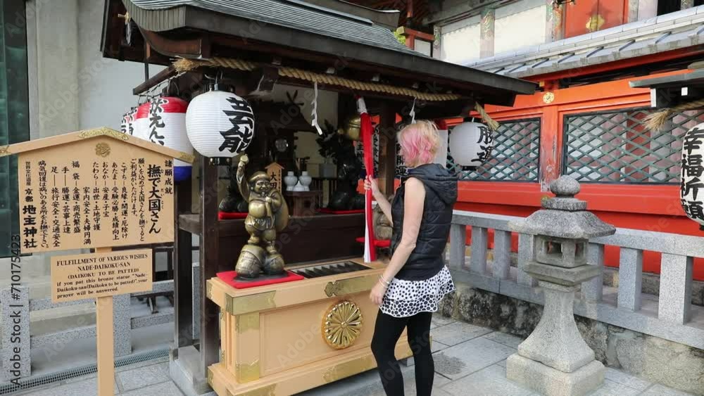 Woman prays at Jishu Jinja Shrine, located above main hall of ...