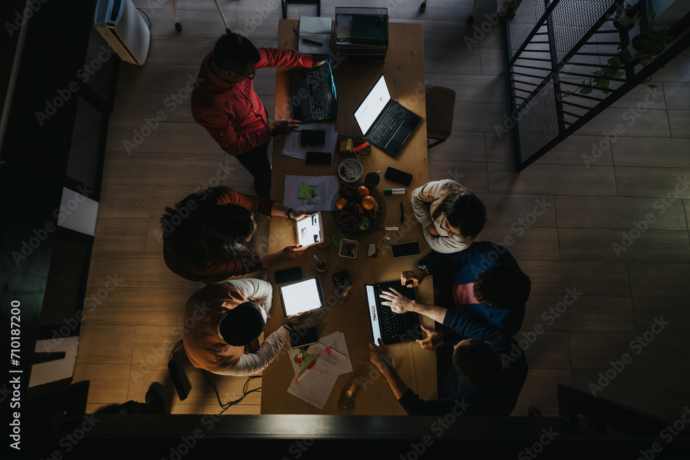 Cross-generational team analyzing statistics and collaborating for ...