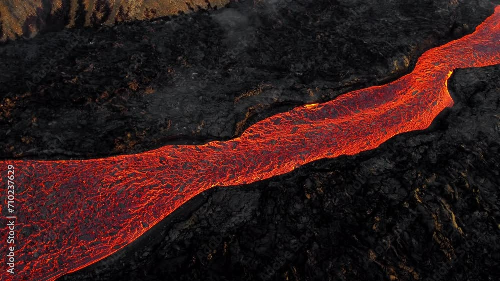 Lava river from active volcano. Red hot burning lava erupts from ground ...