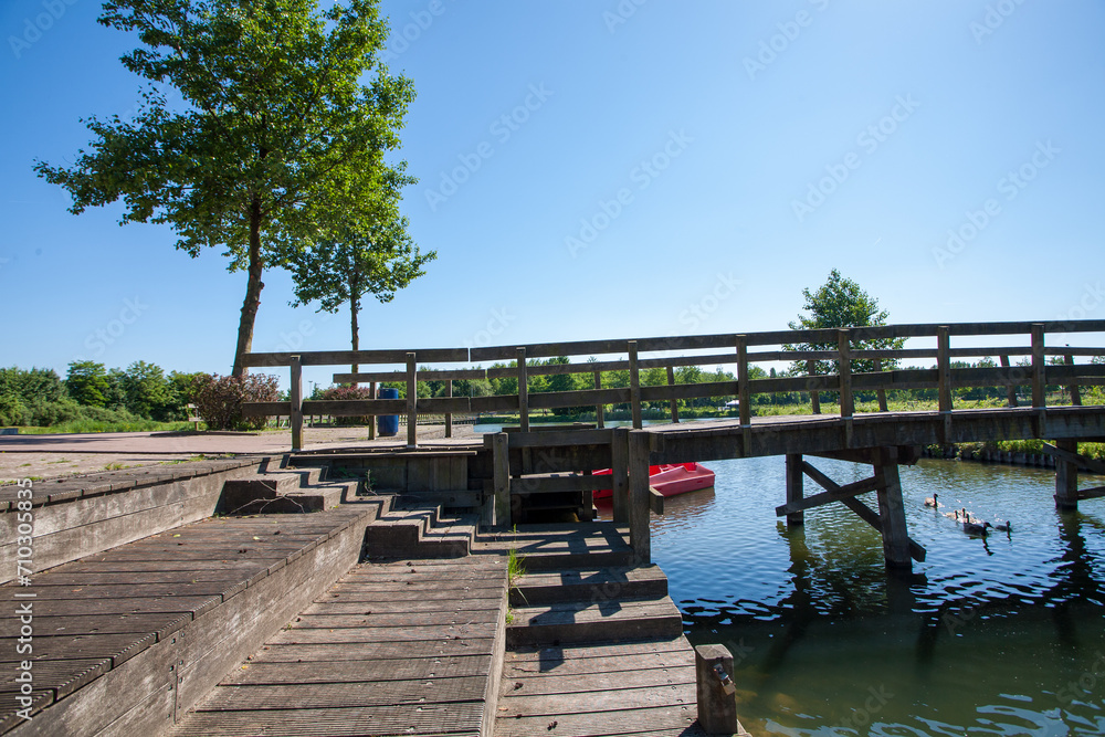 This tranquil image captures a wooden jetty stretching out into a calm ...