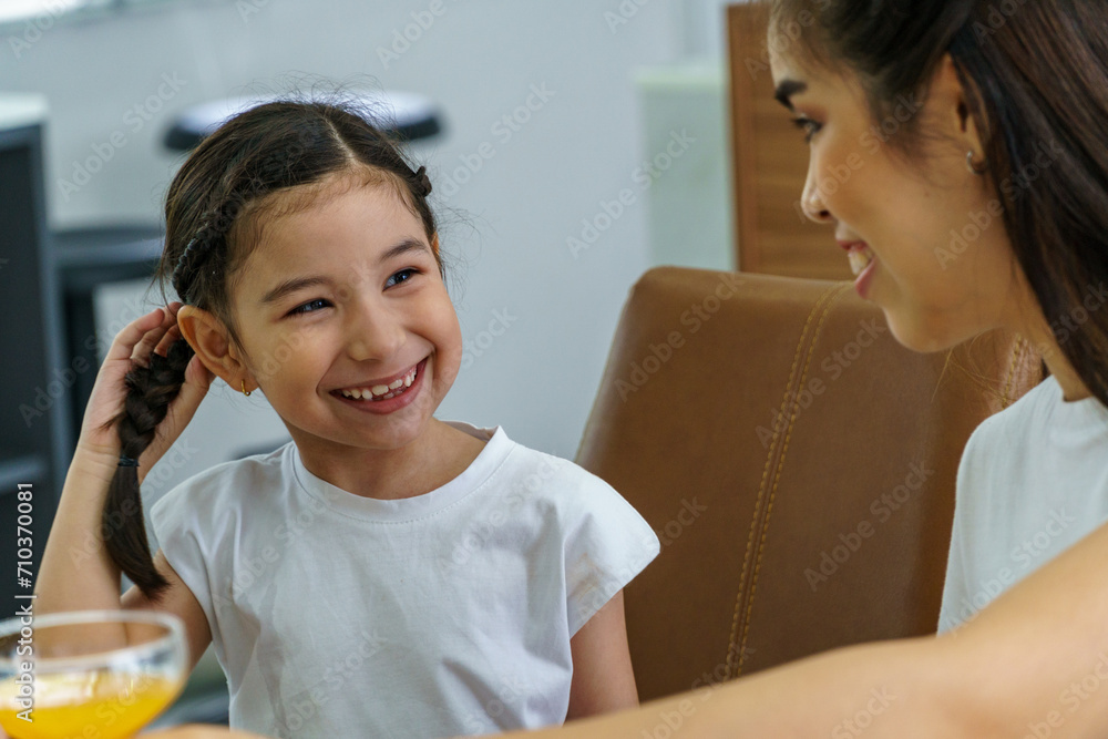 Little girl talking with mom with Happy family eating on the dining ...