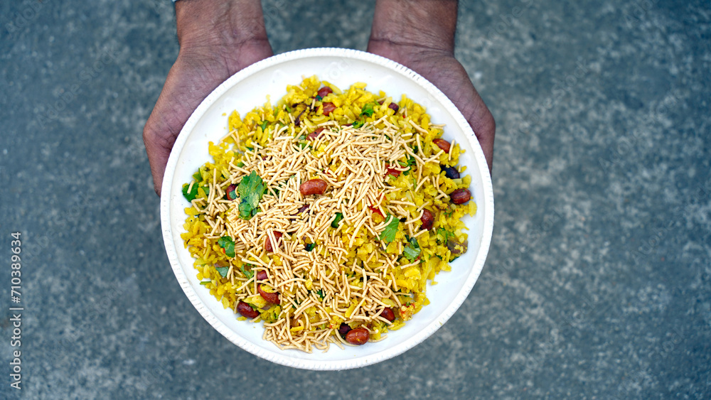 indian breakfast dish poha.Indian breakfast Poha topped with peanuts ...