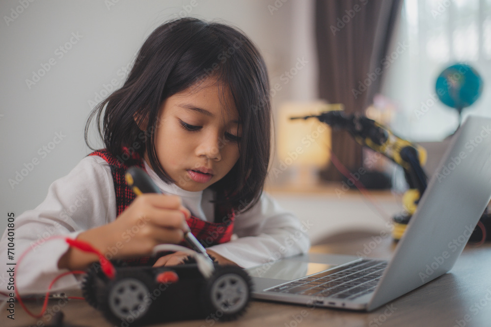 STEM education concept. Asian students learn at home by coding robot ...