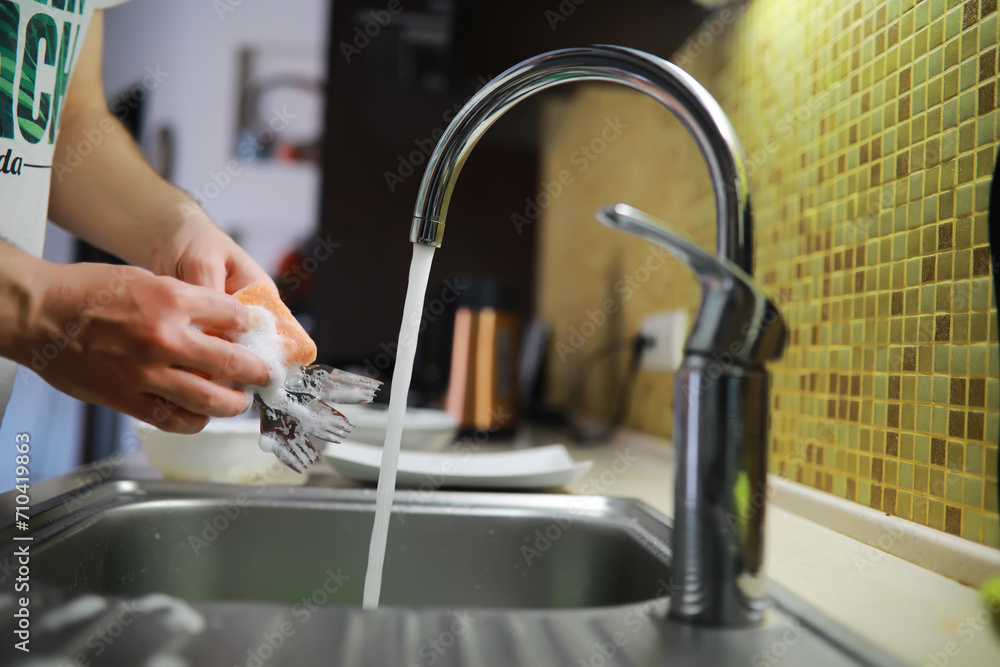 Man washing dish in sink at restaurant.People are washing the dishes ...