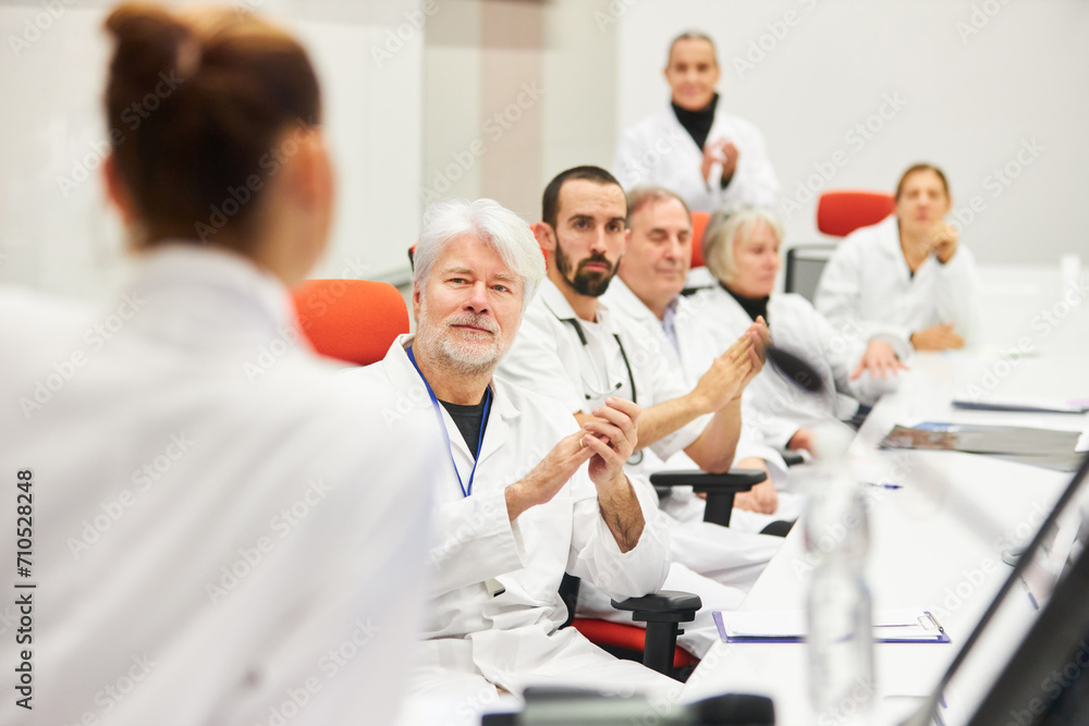 Doctors panel at medical conference discussing on stage in auditorium ...