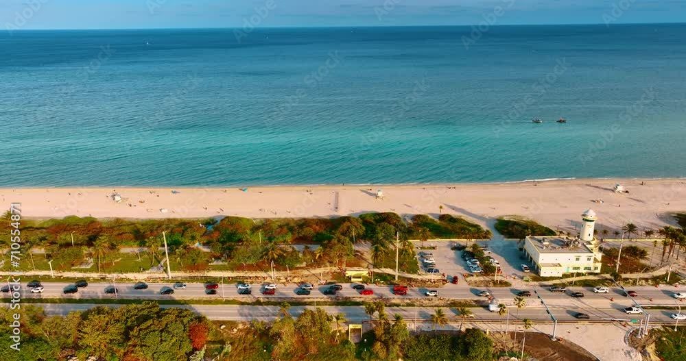 Cars move slowly by the highway through the picturesque beach ...