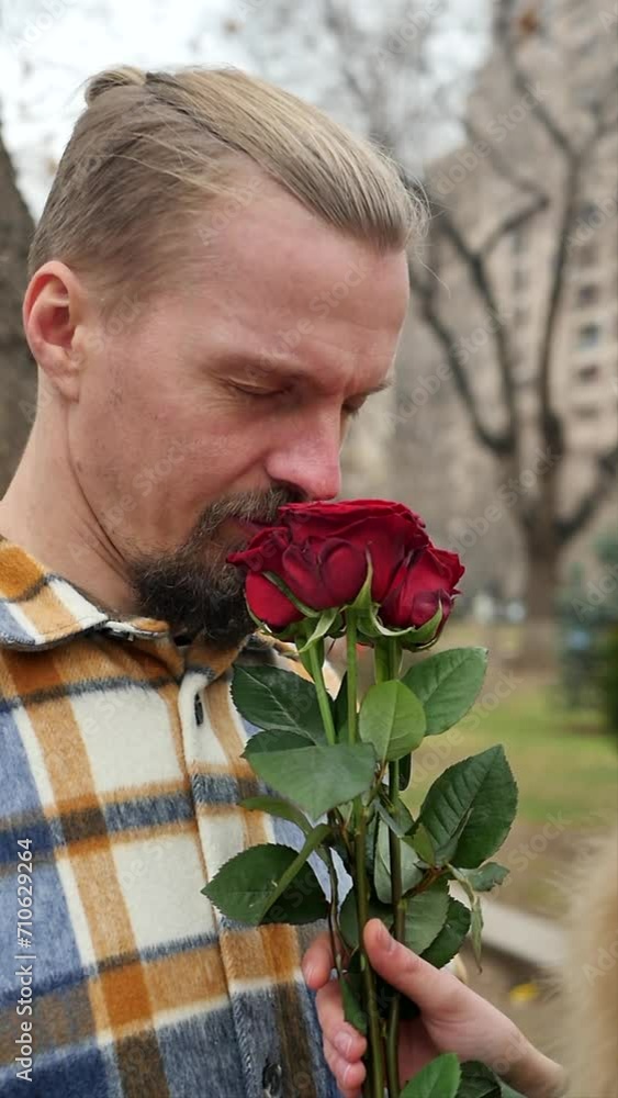 Vidéo Stock A young attractive man sneezes in reaction to pollen after ...