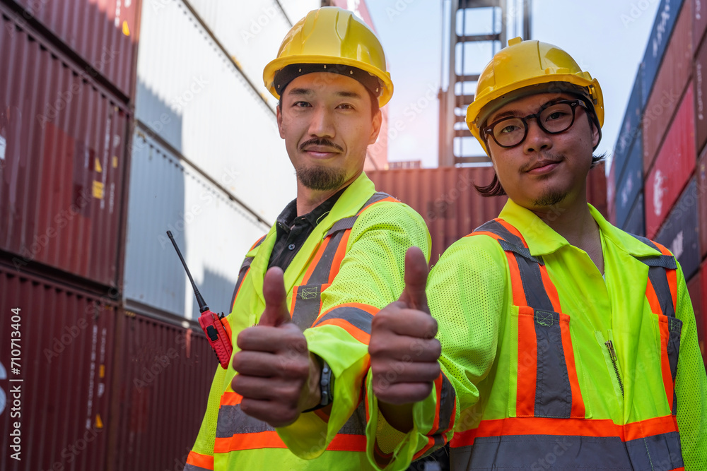 Japanese male engineer and Asian male worker in uniform giving thumbs ...