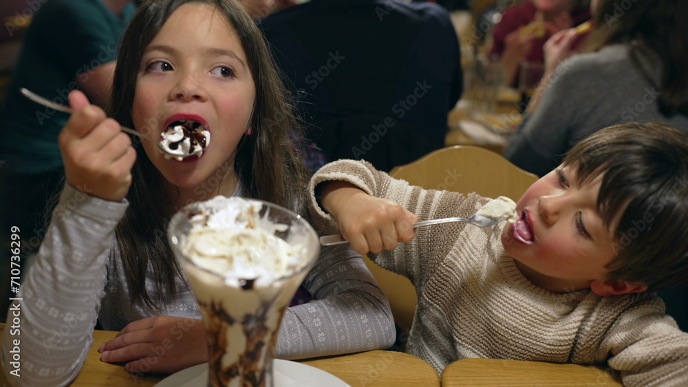 Kdis eating whipped cream sundae at restaurant, brother and sister ...