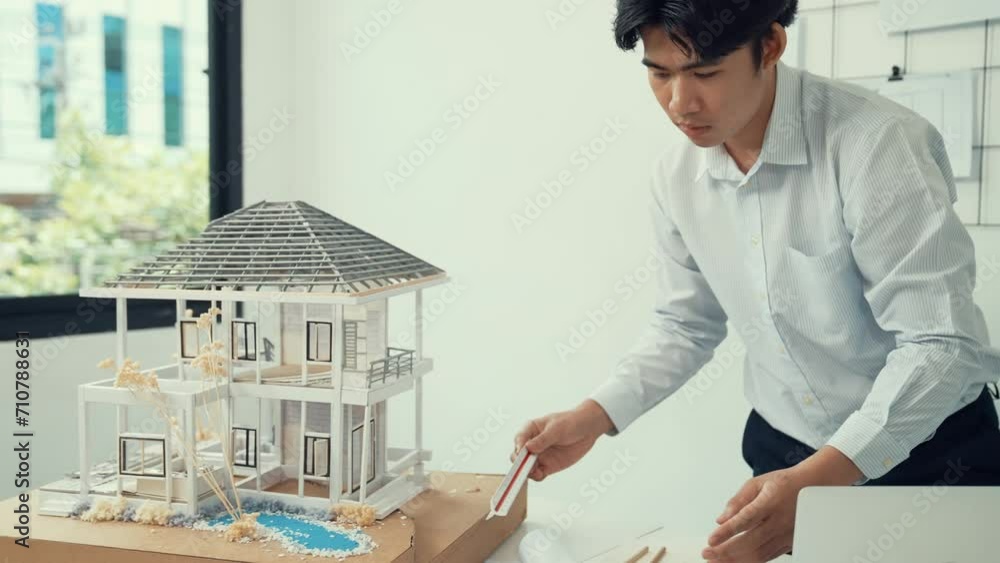 Close up of professional male architect engineer measure house model ...