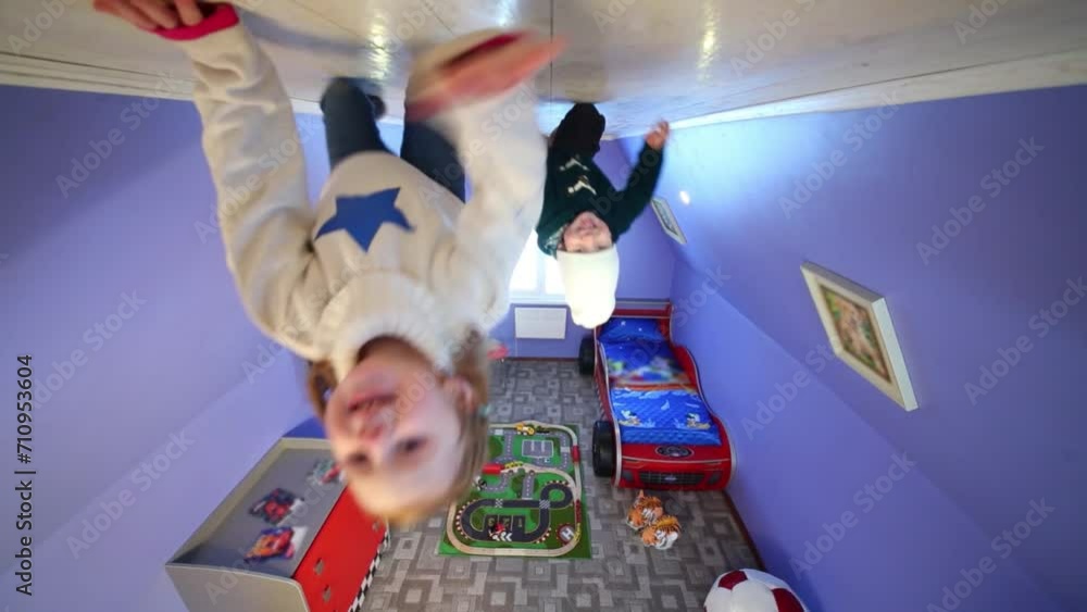 Little girl and boy crawl on ceiling upside down at inverted house ...