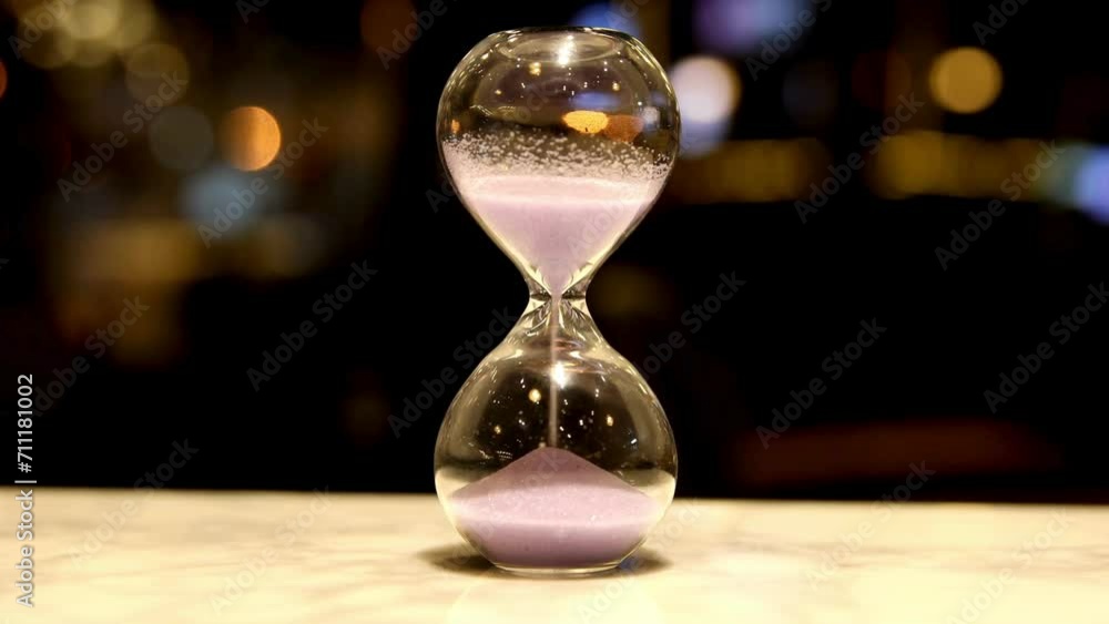 hourglass on table, sand flowing through the bulb. hourglass made of ...