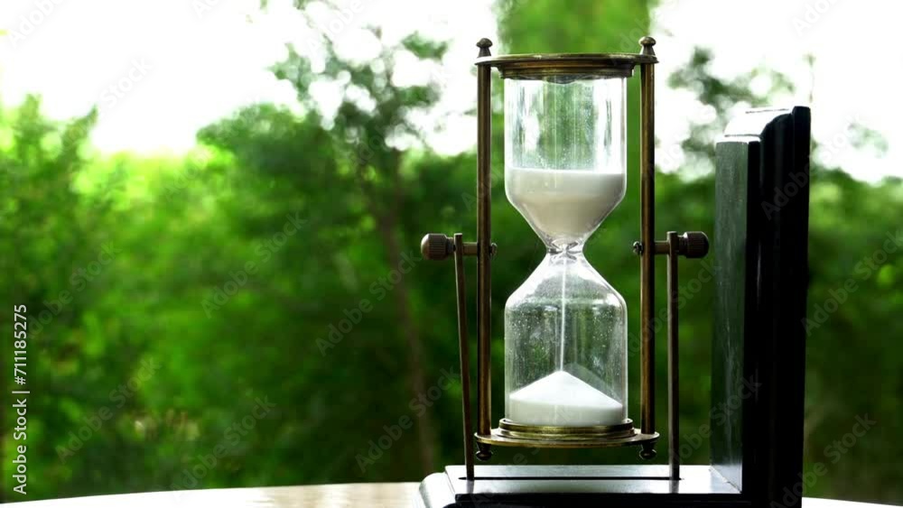 wooden hourglass sand glass white sand run on blurred nature background ...
