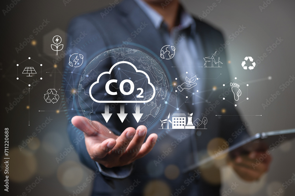 Reduce CO2 emission concept, businessman holding CO2 emission icon ...