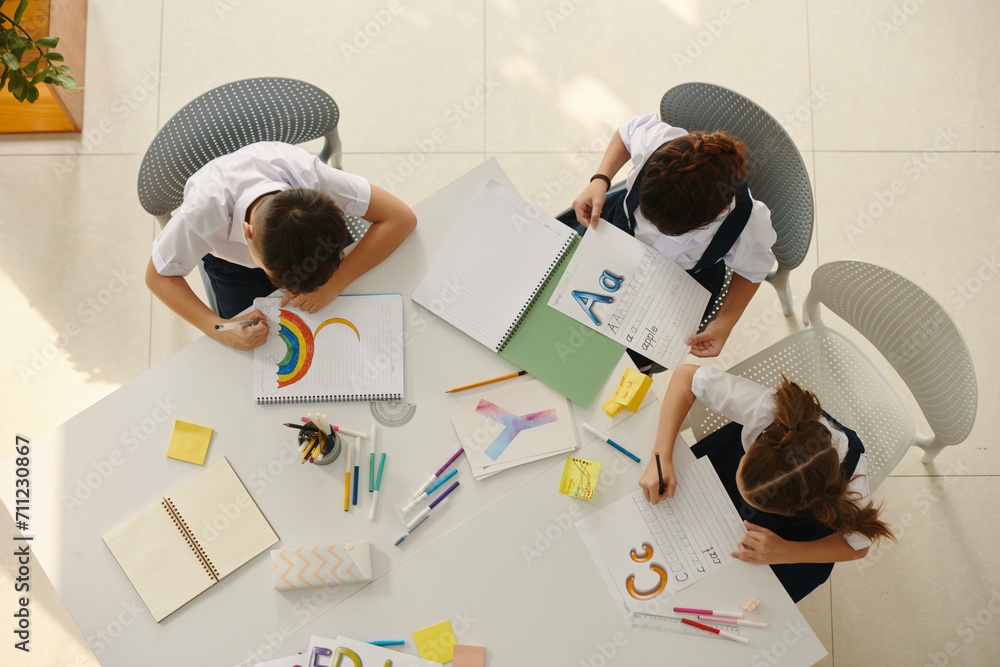 Kids learning English alphabet and practicing writing letters Stock ...