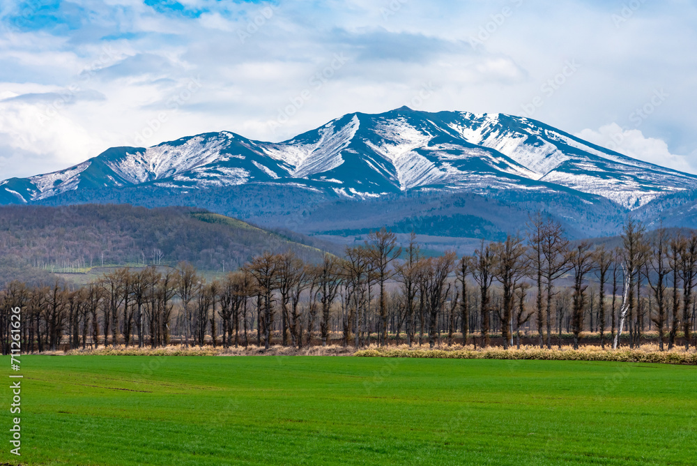 Rural landscapes. Rolling mountain range, farmland field and blue sky ...