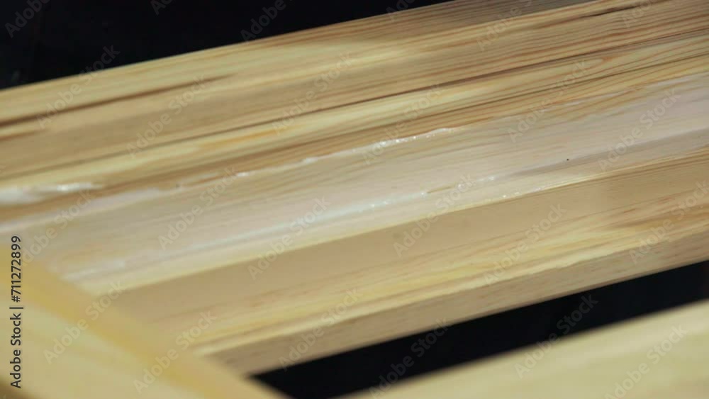 Putting a lot of glue on the timber planks attached to the wood window ...