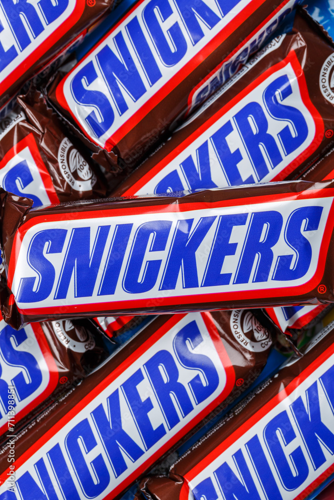 Snickers chocolate bars from Mars Inc. as a background portrait format ...