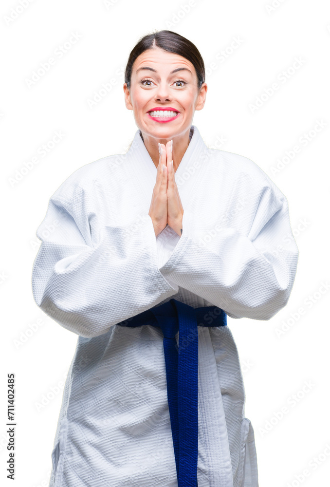 Young beautiful woman wearing karate kimono uniform over isolated ...