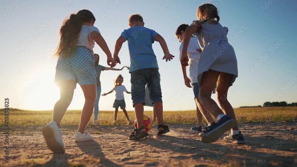 happy family playing ball in the park. a group of children playing ball in nature. happy family ...
