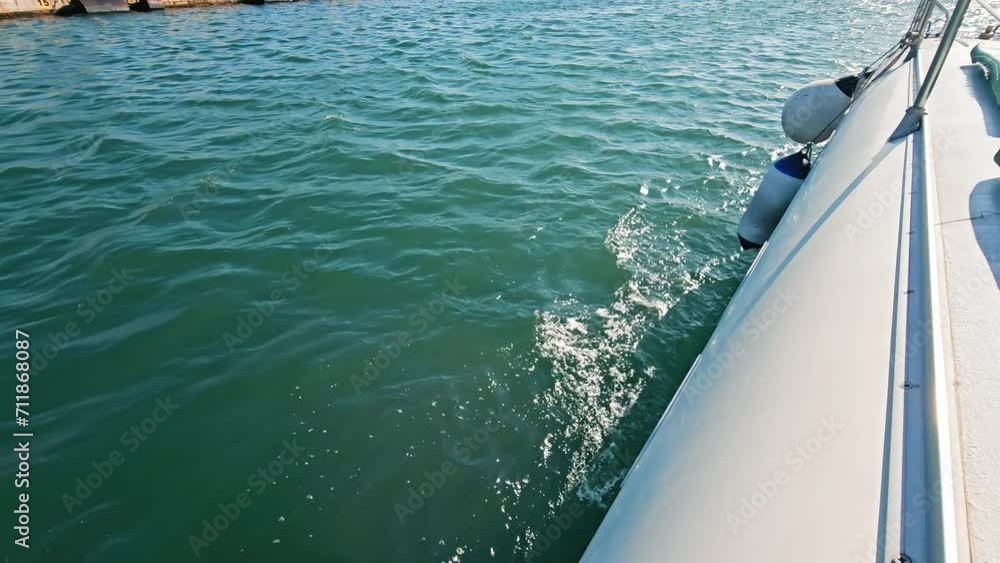 Sailboat Cruising on Open Water, Side view of a sailboat hull moving ...