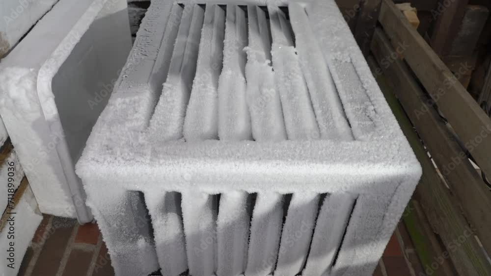 Air source heat pump outdoor unit covered with snow and frost due to ...