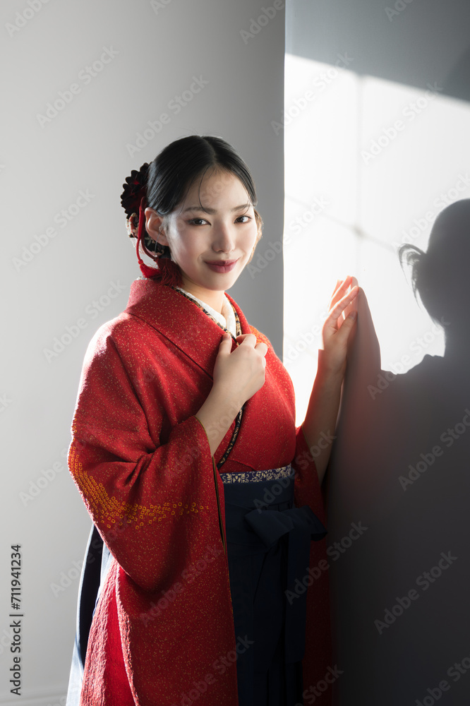 Beautiful young Japanese woman in kimono, ennui expression, looking at ...