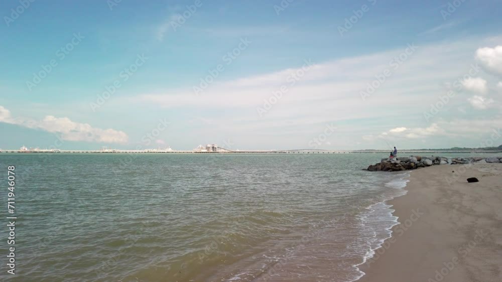 A drone-like low-to-high angle shot captures the coastal serenity of ...