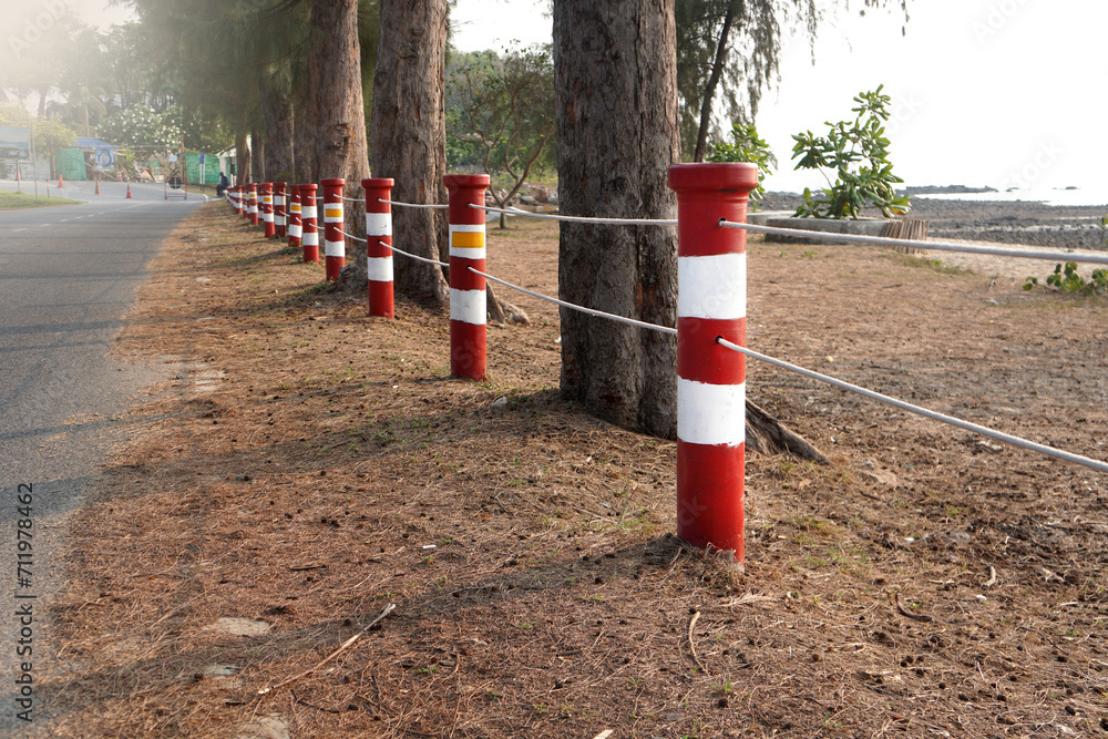 Red and white fence posts mark the boundaries of the road. Stock Photo ...