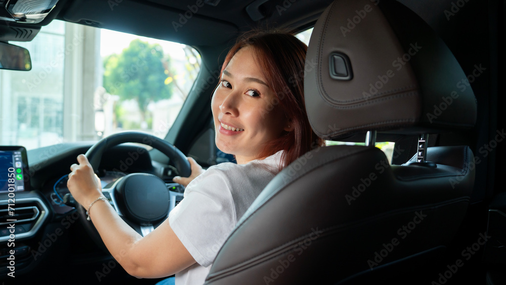 Beautiful Asian female driver smiles to welcome passengers. Stock Photo ...
