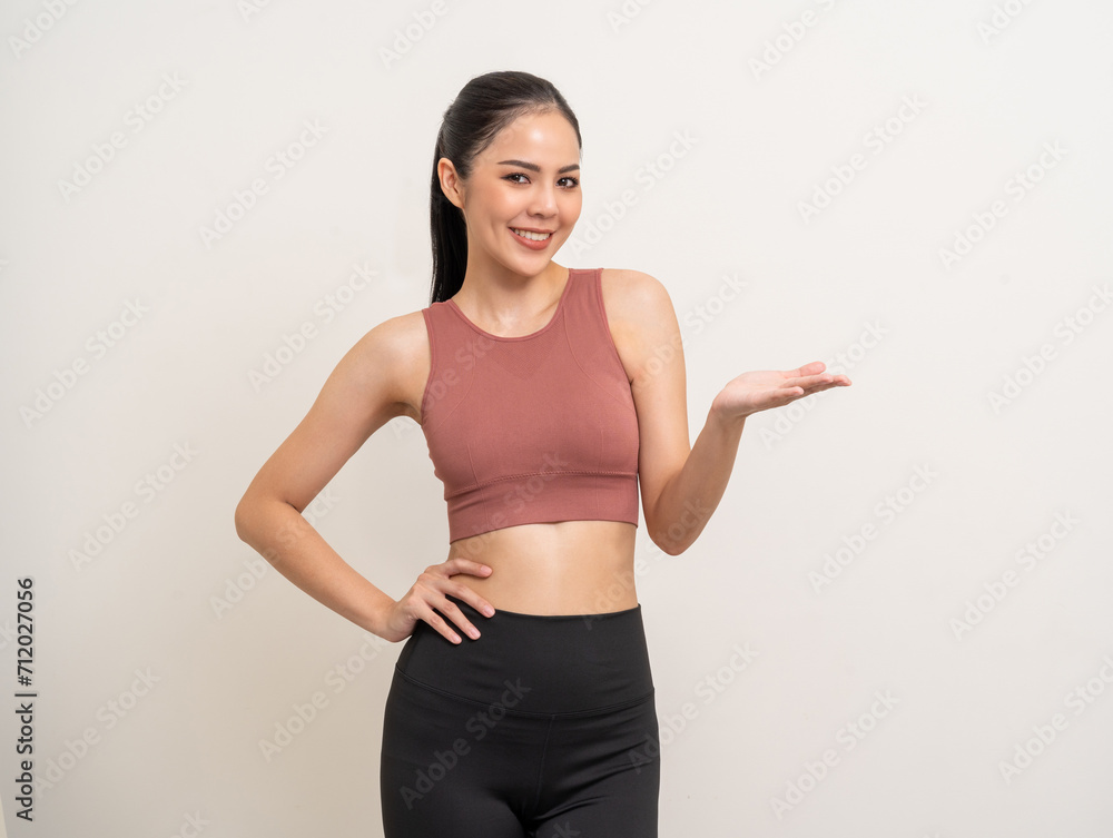 Young beautiful smiling asian woman with sportswear hand palm up with ...
